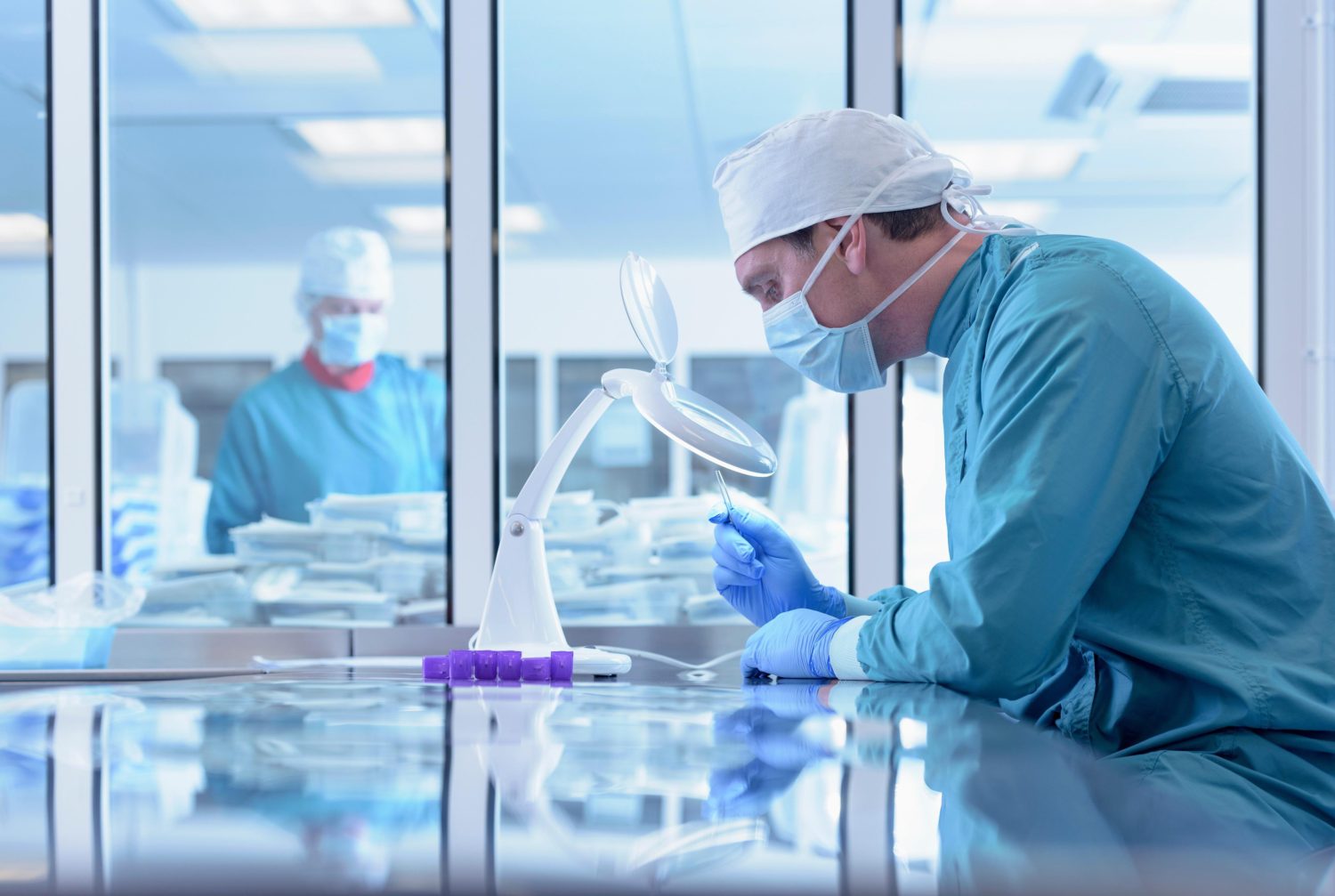 Workers inspecting surgical instruments in clean room of surgical ...